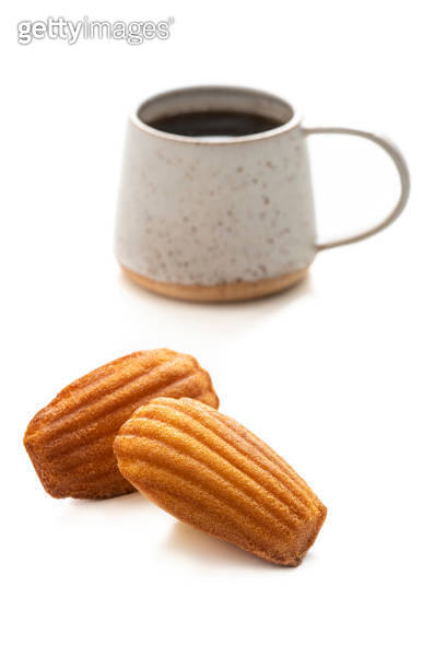 Madeleines french small sponge cakes with shell shape with cup of ...