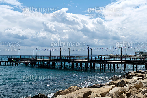 Sea pier on Molos promenade with national flags garlands, Limassol ...