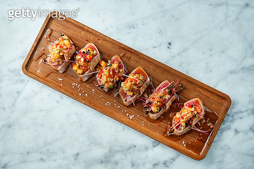 Japanese classic dish - tataki tuna with unagi sauce, hot pepper ...