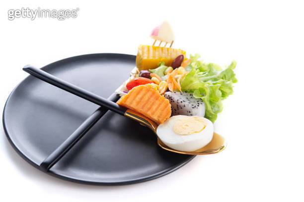 20:4 fasting diet concept. One third plate with healthy food and two ...