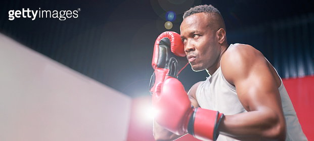Portrait young fit strong black African man wearing boxing gloves ...