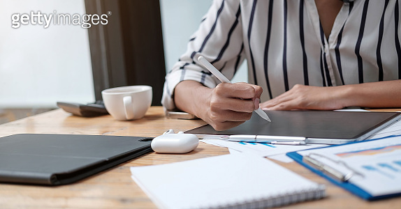 business woman hands holding electronic pen ( stylus pen ) and working ...