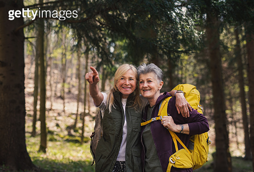 Senior women hikers outdoors walking in forest in nature, talking. 이미지 ...