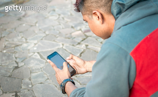 Close up of a man with cell phone in hand, close up shot of a person ...