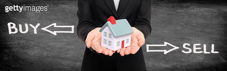 Real estate broker showing miniature house for buy and sell home ...