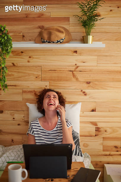 Happy woman laughs while telecommuting from her room 이미지 (1304445218 ...