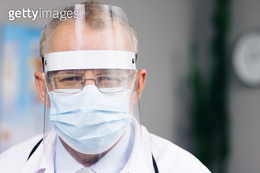Portrait of male Doctor in Glasses Wearing a Transparent Protective ...