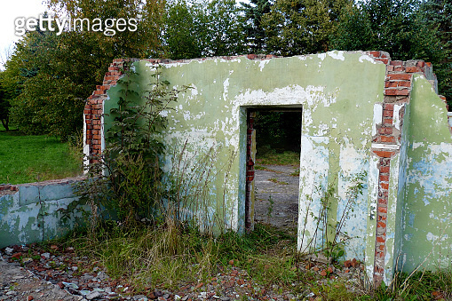 A small, ruined, ruined brick building. Part of the wall and the ...