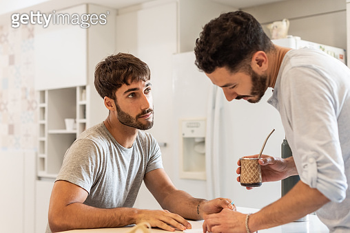 Young couple sharing a mate infusion and reading a shopping list ...