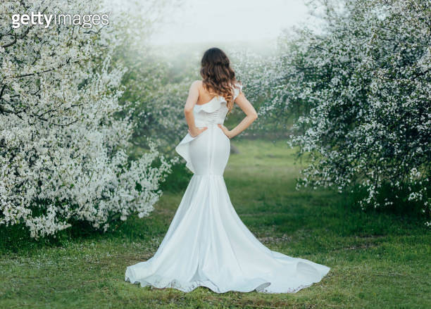 Silhouette of mysterious fantasy woman in long white elegant dress ...