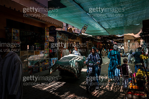 Street scene in the city of Marrakesh, with people shoping in the old ...