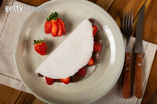 Sweet tapioca stuffed with chocolate and strawberry. Brazilian tapioca ...
