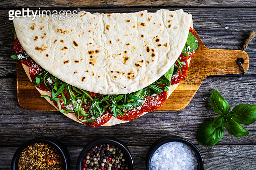 Italian piadina wraps - piada stuffed with salami, parmesan and arugula ...