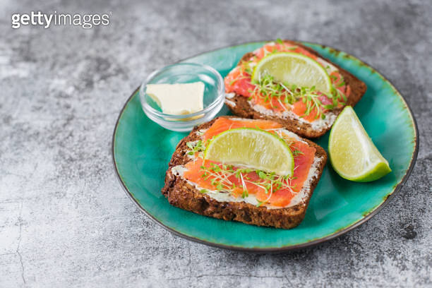 Two toast sandwiches on dark grain bread with butter, lightly salted ...