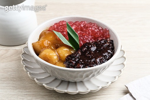 Indonesian traditional dessert. Black glutinous rice with Candil and ...