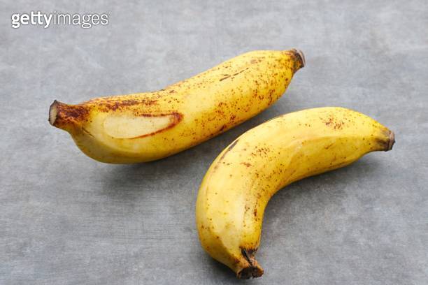 The bananas is medium ripe with brown spots all over the yellow skin ...