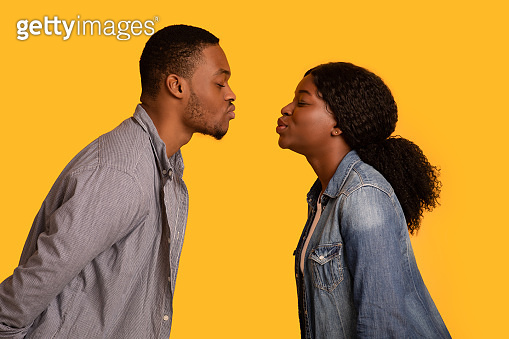 First Kiss. Romantic black couple reaching out each other for kissing ...