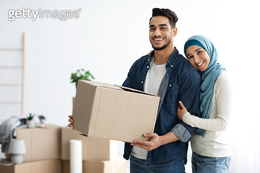 Pretty muslim lady hugging her husband holding paper box (1342213043 ...