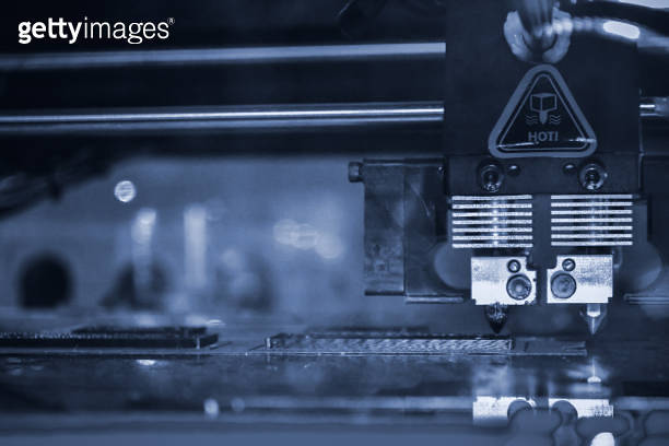 3D printer printing black shapes close-up Automatic three dimensional ...