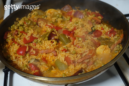 Fried rice being cooked with sausage tomato peppers and bacon bits ...