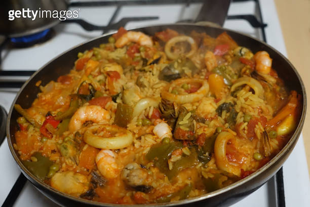 Paella being cooked Long grain rice cooked with spices Varied seafood ...