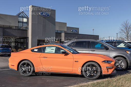 Ford Mustang display at a dealership. Ford offers the Mustang in a base ...