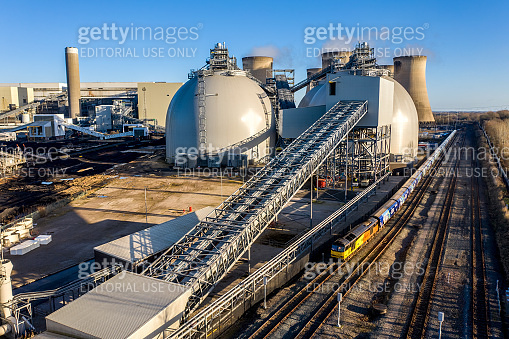 Aerial view of Biomass fuel storage tanks and freight train delivering ...