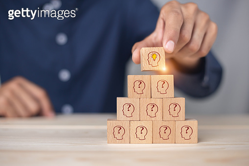 Hand business picked wooden cube block with head human symbol and light bulb icon creative idea ...