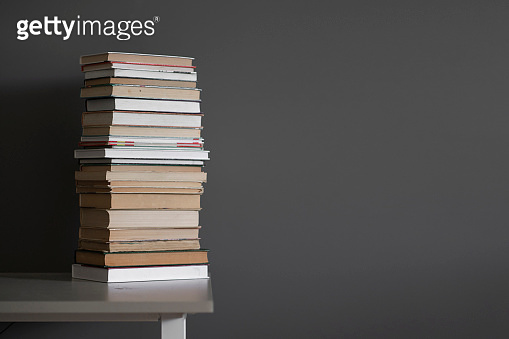 a stack of books on the shelf, concept of homework and studying ...