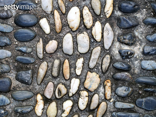 pathway decorated with pebble river stone (sea stone) embedded in ...