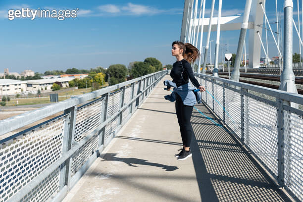 Young active sporty business woman morning routine of stretching and ...