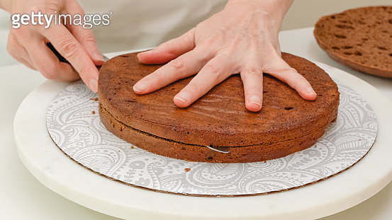 Chocolate cake step by step recipe. Woman hands slicing fresh baked ...