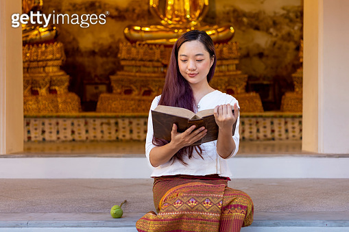 Asian buddhist woman is reading Sanskrit ancient Tripitaka book of Lord ...