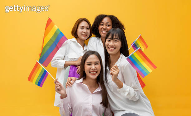 Group of diversity woman friends waving LGBTQ rainbow flag for pride ...