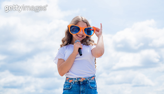 child singing outdoor. singer with microphone. happy childhood. happy ...