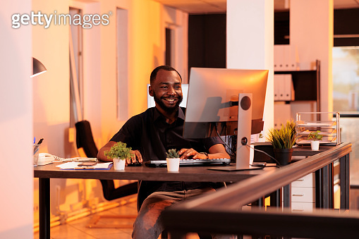 Smiling employee working on computer to do research 이미지 (1423276564 ...