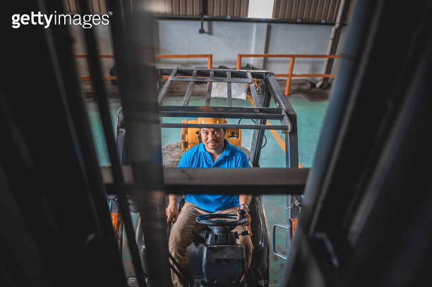 portrait asian forklift driver looking at camera smiling loading ...