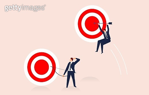 One businessman jumps up to catch the arrow hit by the tall bullseye ...