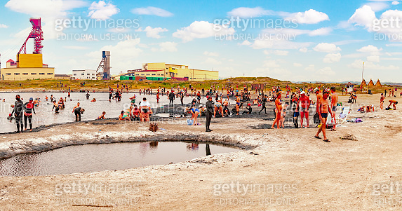 Lake Tuzluchnoye. People take medicinal baths on a mud lake. View of ...