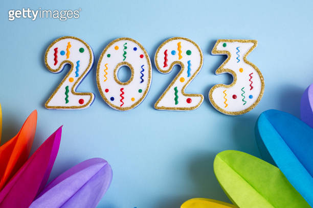 Multicolored numbers 2023 on the blue background.Bright paper decor ...