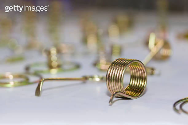 close up shiny golden color of flexibility metal coil spring for ...