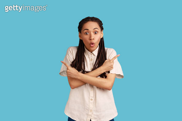 Woman points fingers in different sides, demonstrates two directions ...