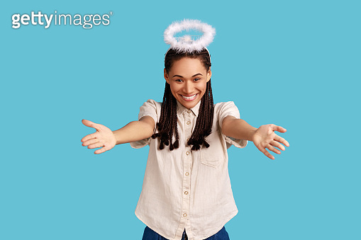 Angelic woman with nimbus keeping hands open to embrace, giving welcome ...