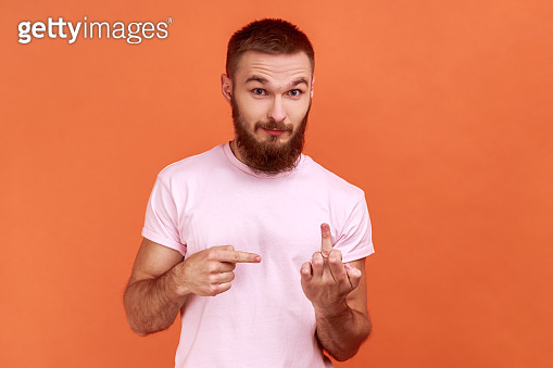 Aggressive hater, angry man pointing at his middle finger, rude gesture ...