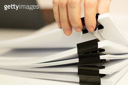 Close-up of woman hand pick up stack of report papers document with ...