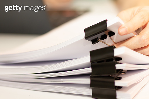 Close-up of woman hand pick up stack of report papers document with ...