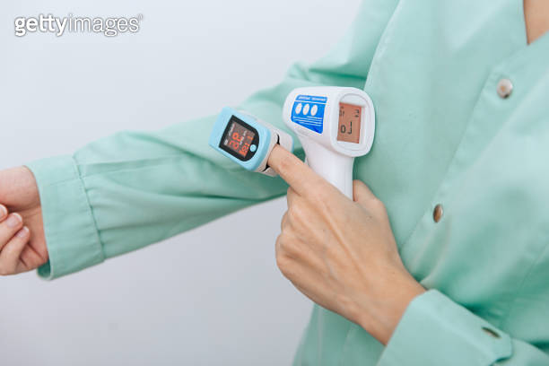 Temperature measurement gun in doctor hands. Close-up shot of doctor ...