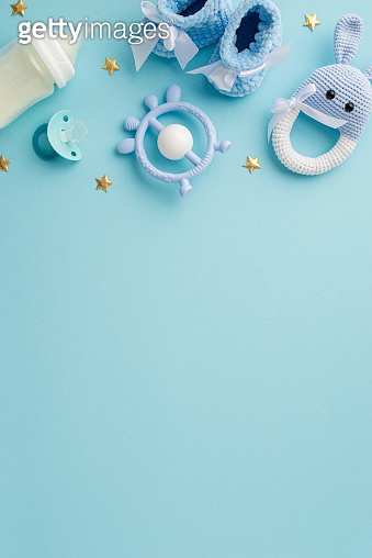 Baby boy concept. Top view vertical photo of booties pacifier teether ...