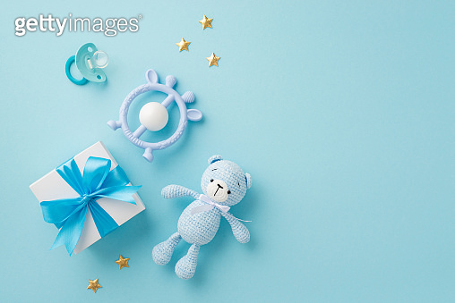 Baby boy concept. Top view photo of giftbox soother rattle knitted ...