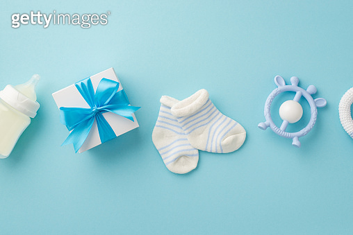 Baby boy concept. Top view photo of giftbox teether milk bottle and ...